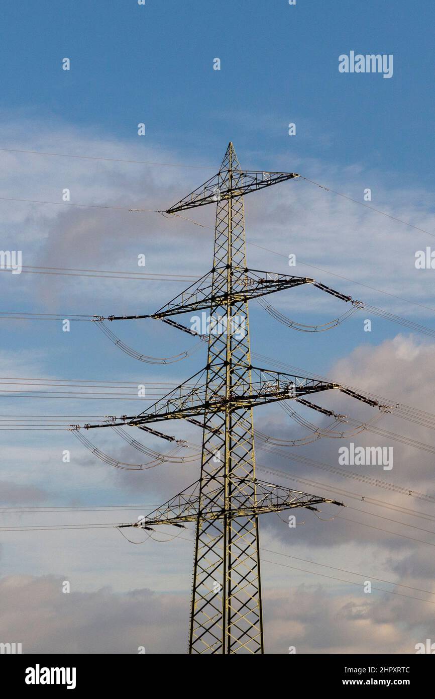 view of electric pylon under clear blue sky Stock Photo - Alamy