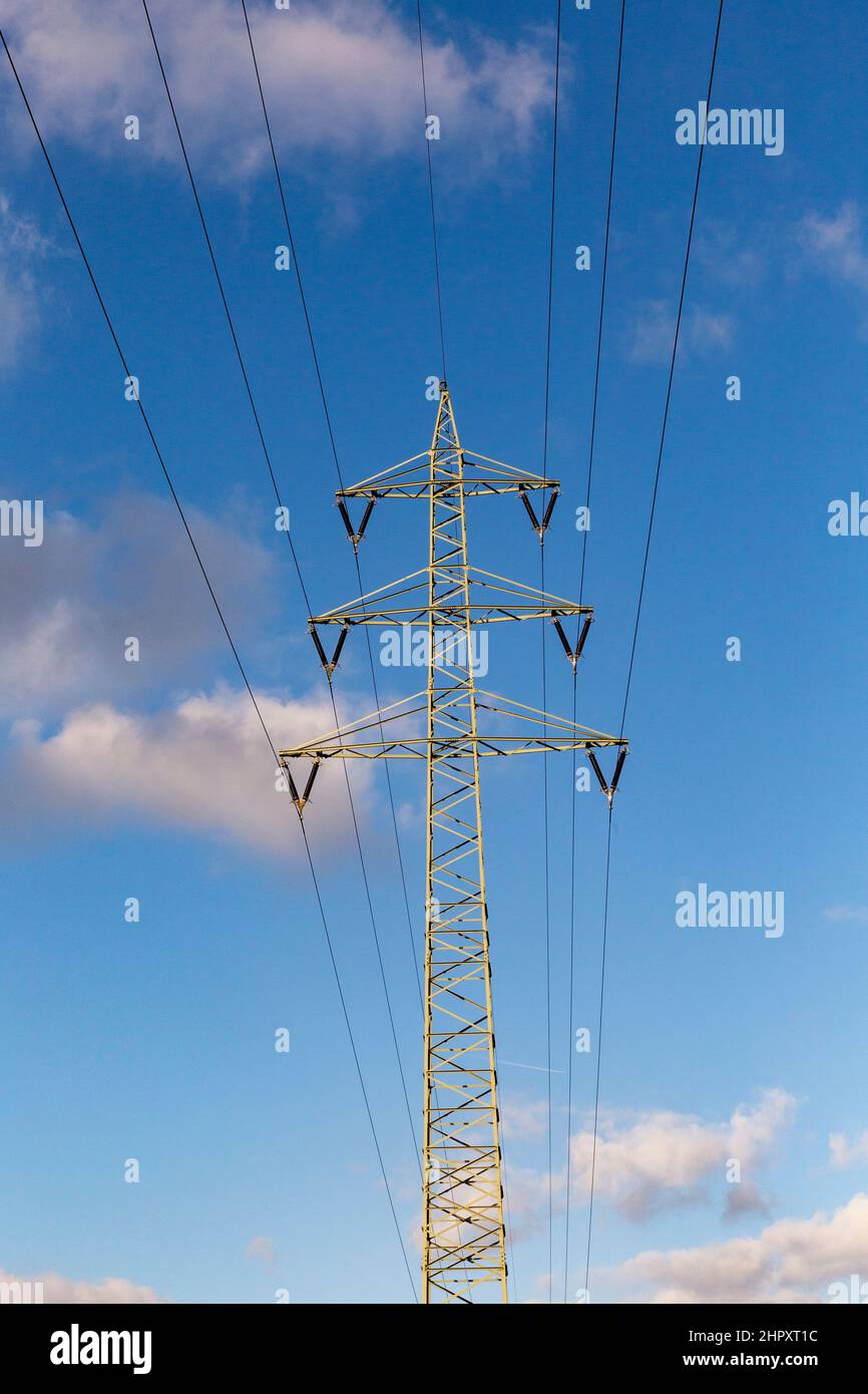 view of electric pylon under clear blue sky Stock Photo - Alamy