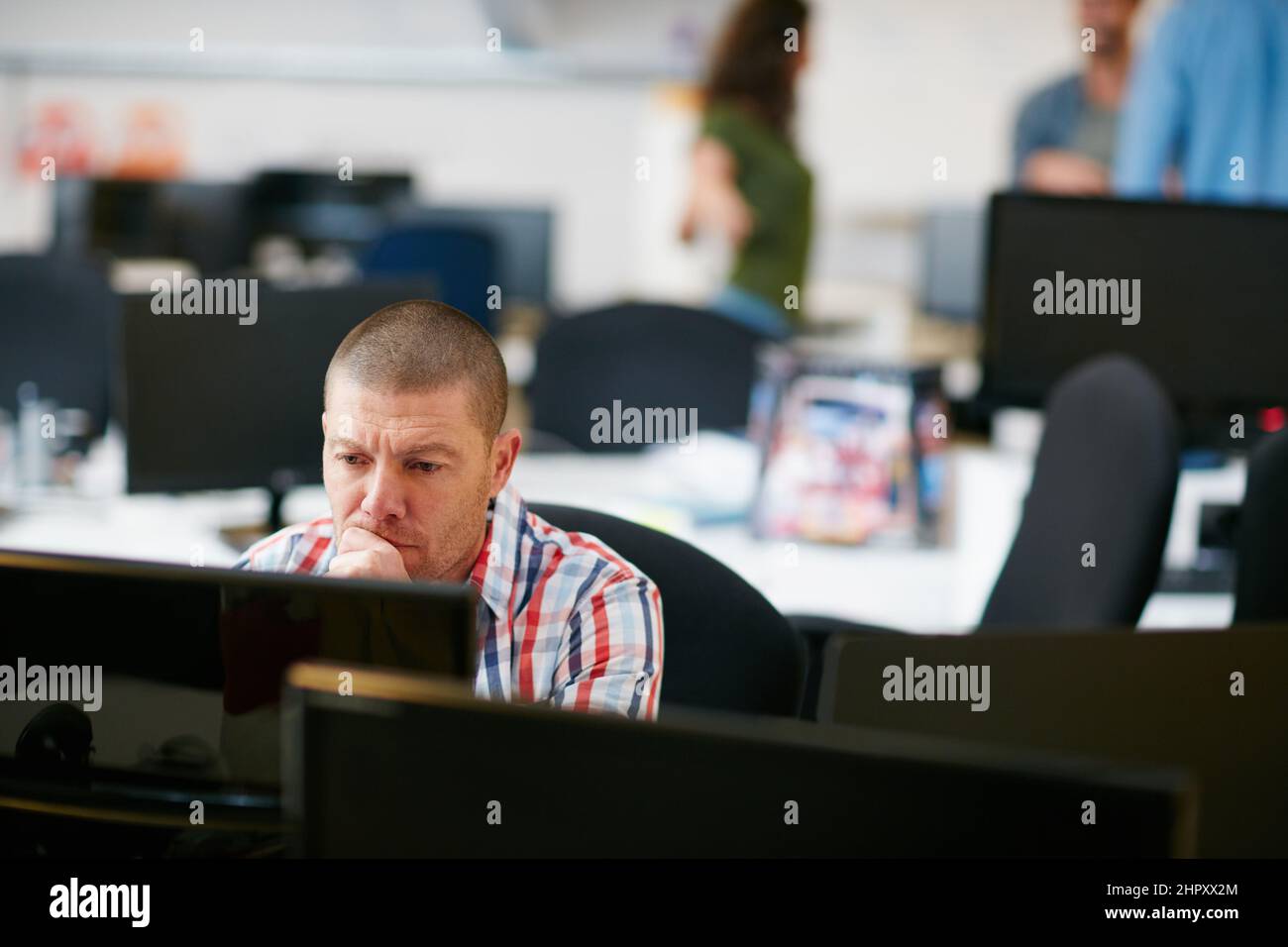 He knows the importance of hard work. Shot of a man using a computer in ...