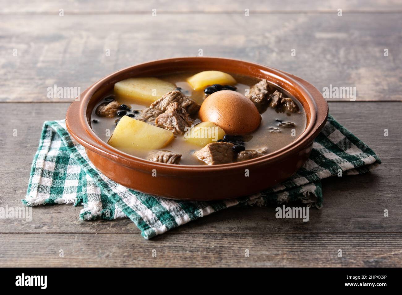 Traditional Jewish cholent on wooden table Stock Photo - Alamy