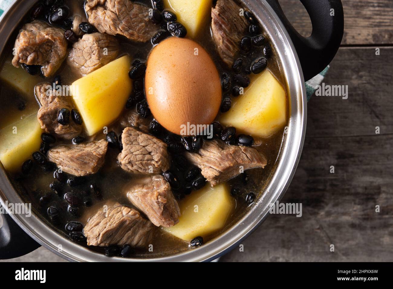 Traditional Jewish cholent in casserole on wooden table Stock Photo - Alamy