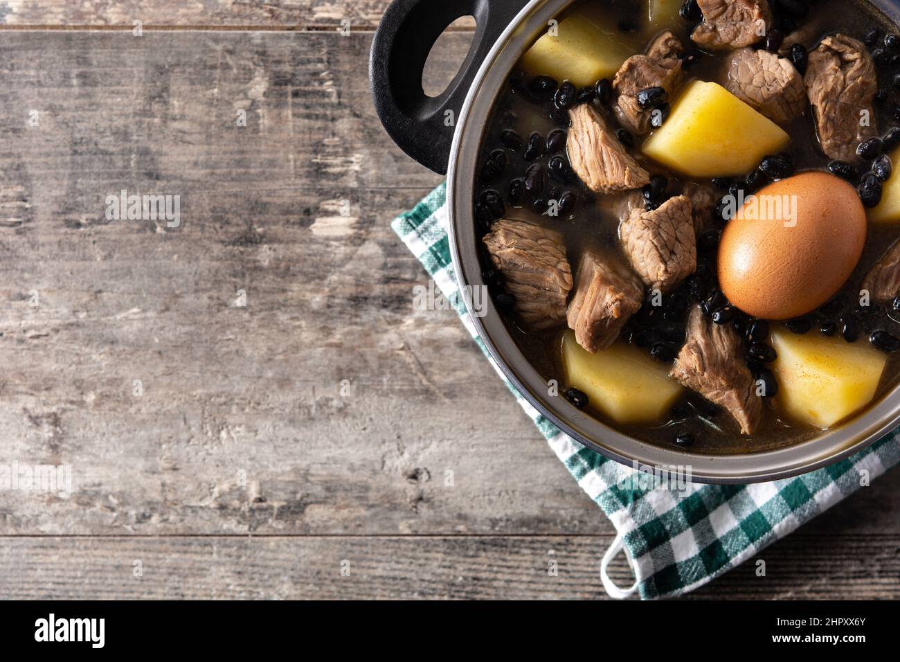 Traditional Jewish cholent in casserole on wooden table Stock Photo - Alamy