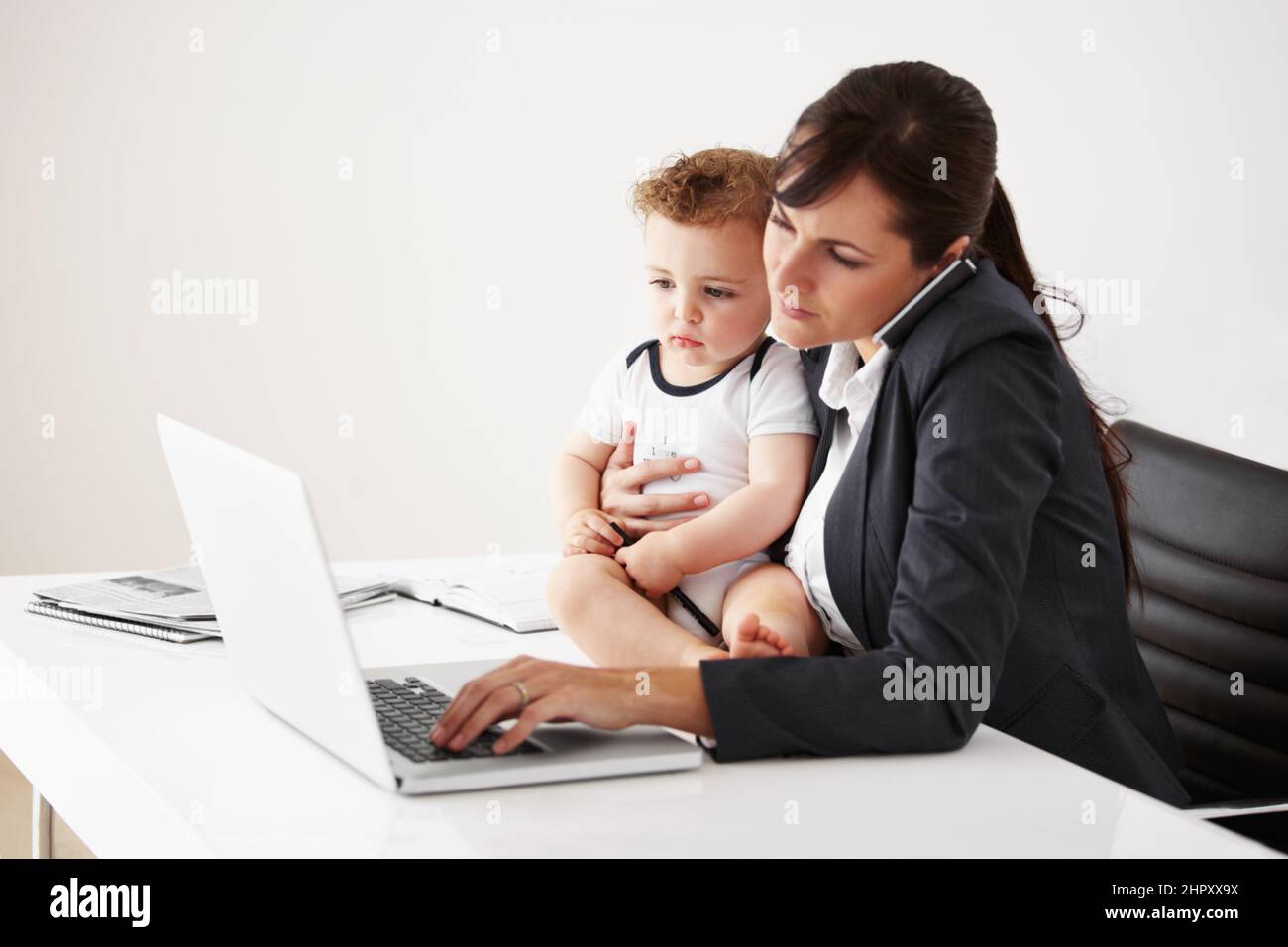 Being a working mom is a balancing act. Working mom talking on the ...