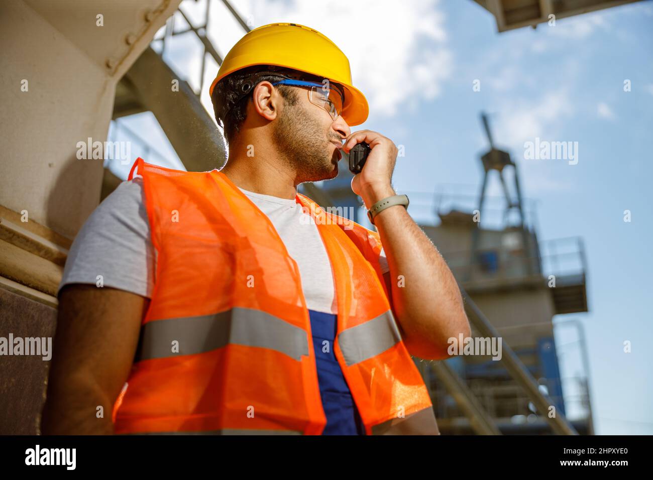 Heavy industrial engineer with walkie-talkie at plant Stock Photo - Alamy
