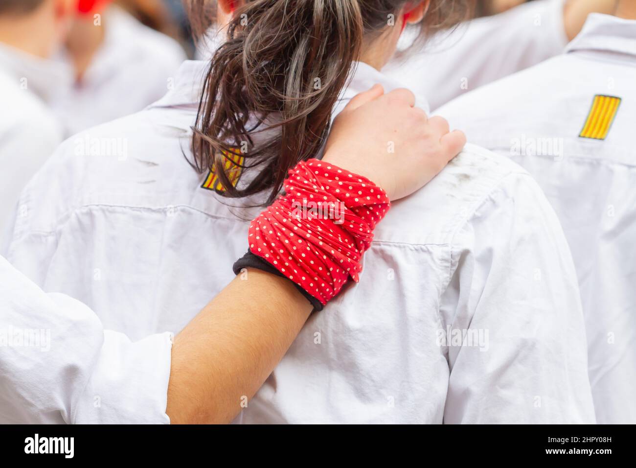 Non-recognizable people with their hand on the back of another ...