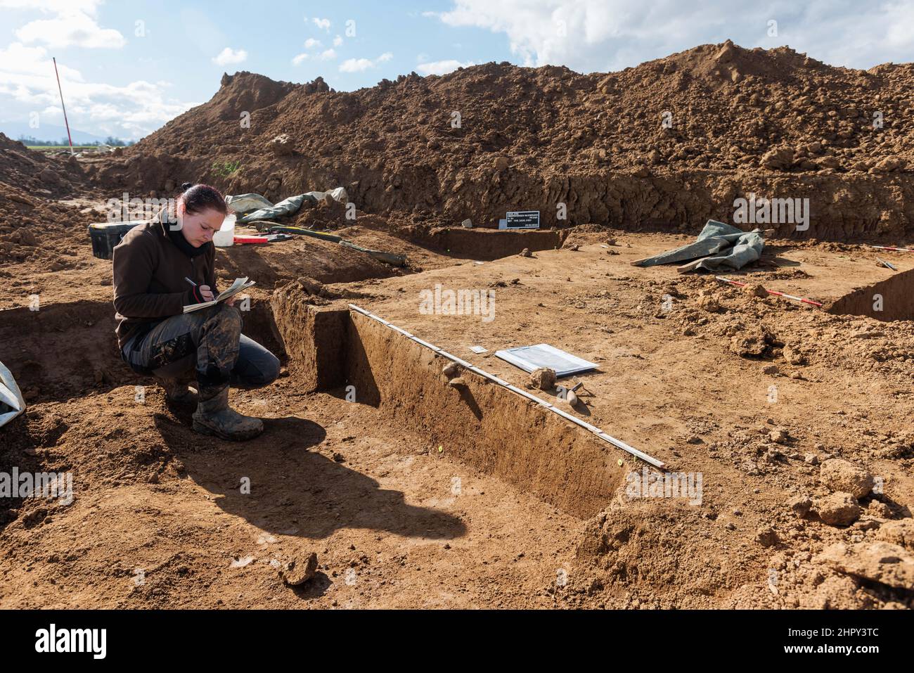 Breisach, Germany. 23rd Feb, 2022. An archaeologist documents the soil ...