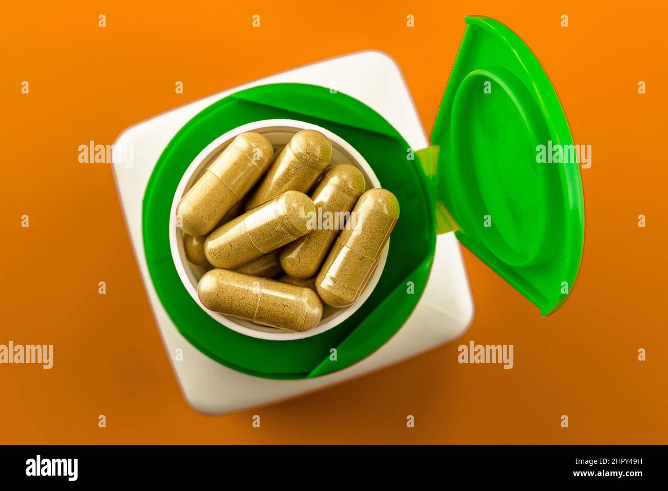 pills capsules top view on yellow background. dietary supplements close ...