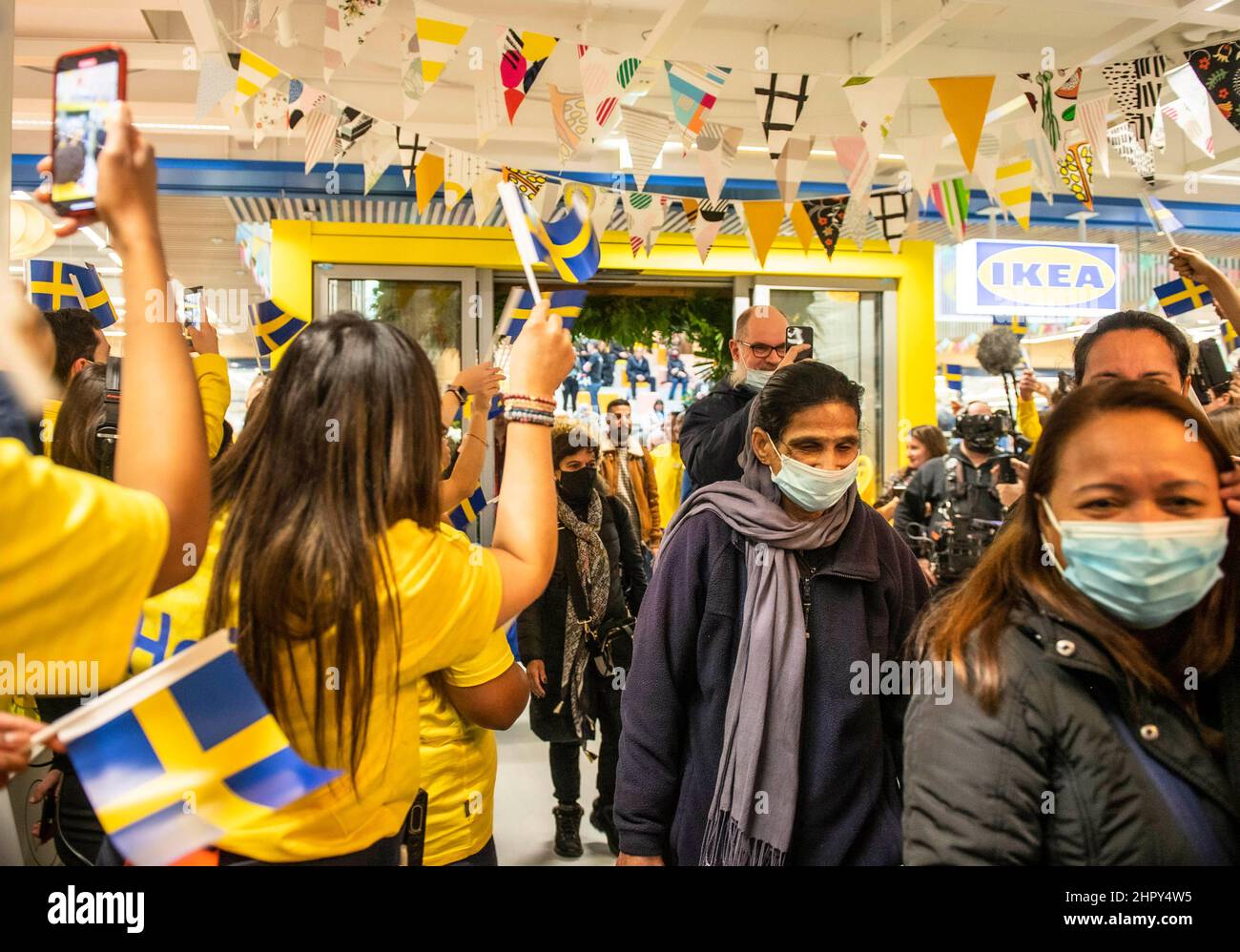 EDITORIAL USE ONLY The first customers are greeted by IKEA co-workers ...
