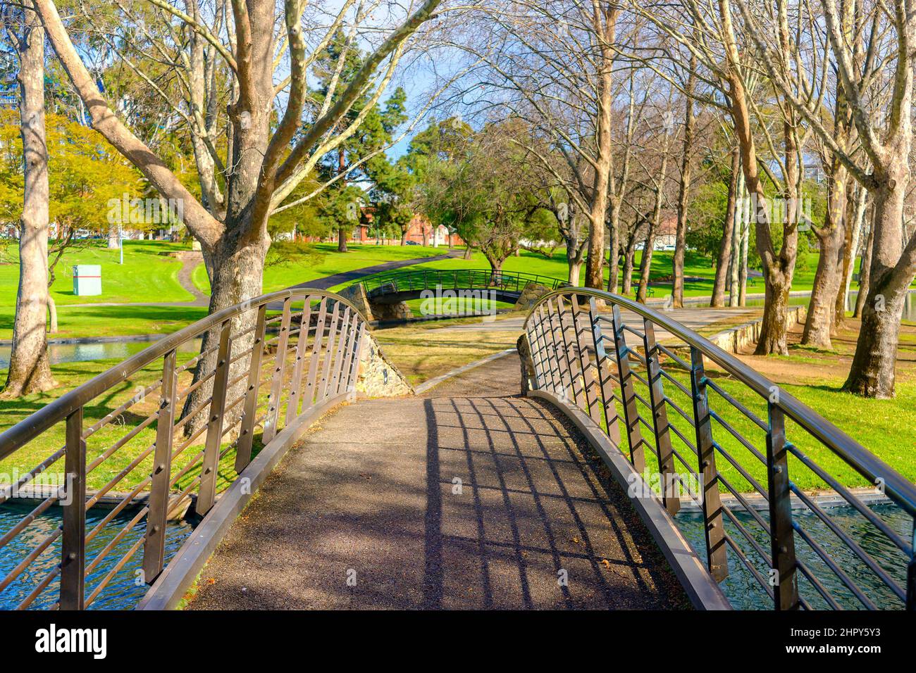 Bridge over the pond at Rymill Park in Adelaide city on a sunny winter ...