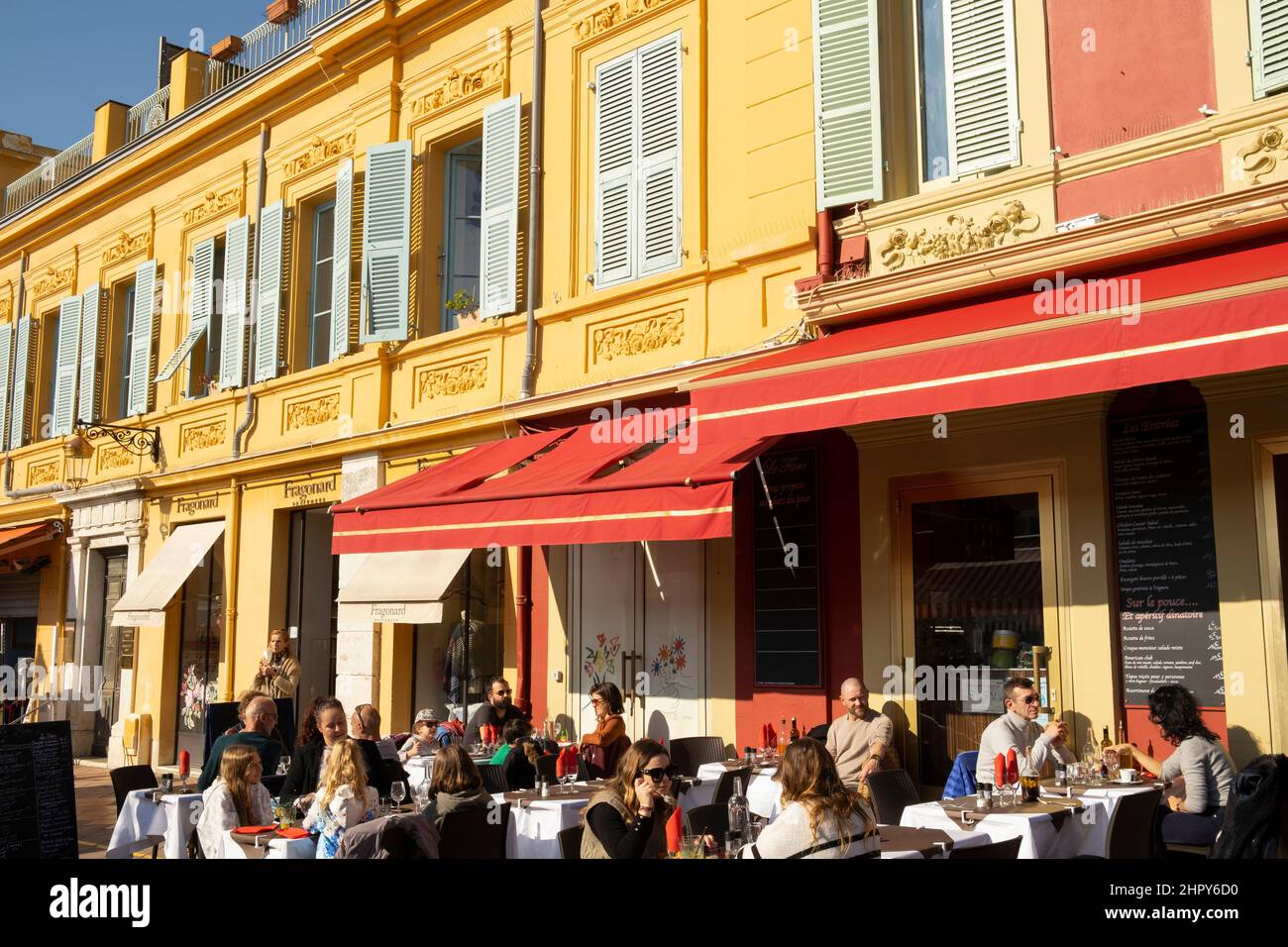People sitting in an outdoor cafe on a sunny winter morning on the ...
