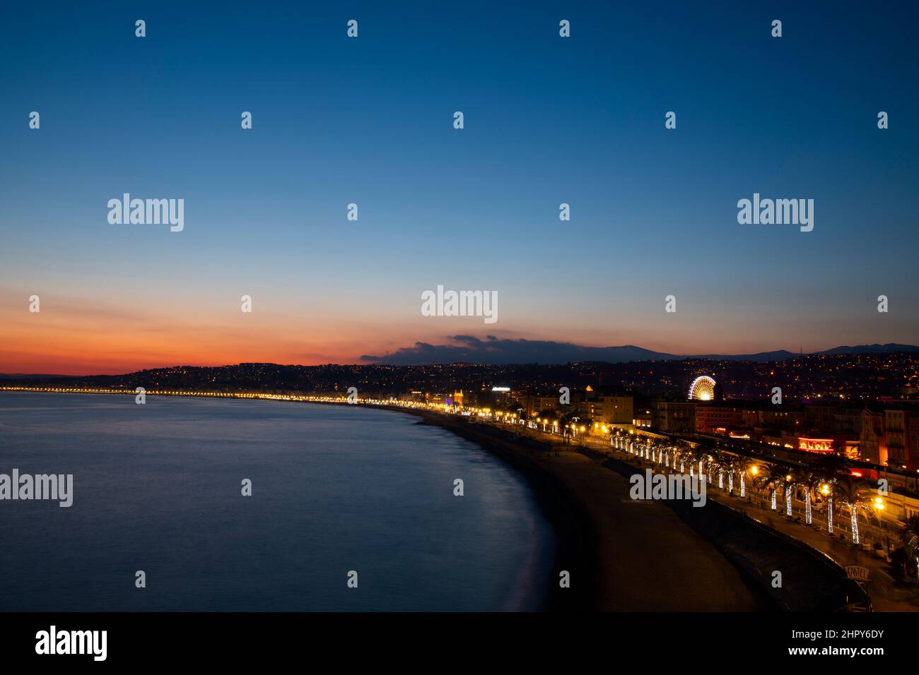 Sunset over the Baie des Anges, the Promenade des Anglais and the city ...