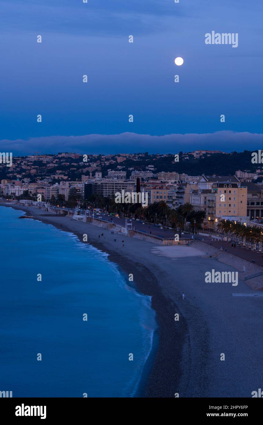 An aerial view of a full moon setting over the Baie des Anges and the ...