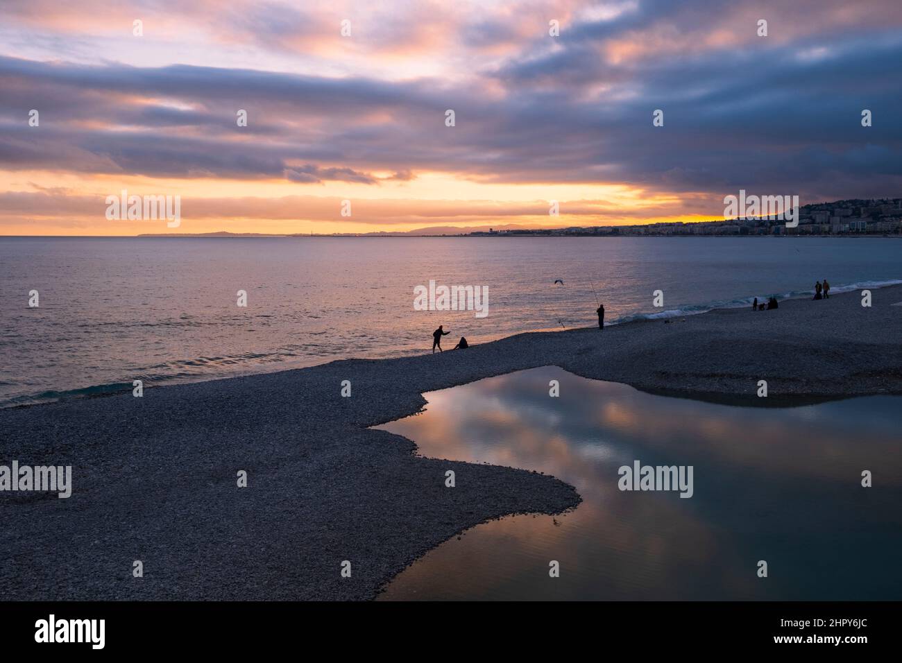 Sunset reflections on the beach in Nice, Cote d'Azur, France Stock ...