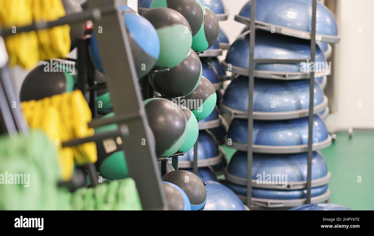 balls, dumbbells and balancing platforms in a gym. sport equipment next ...