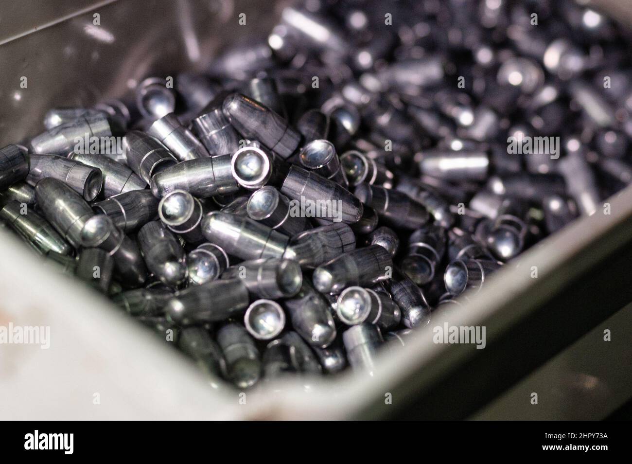 Pile of small caliber hunter bullets in plastic container Stock Photo ...