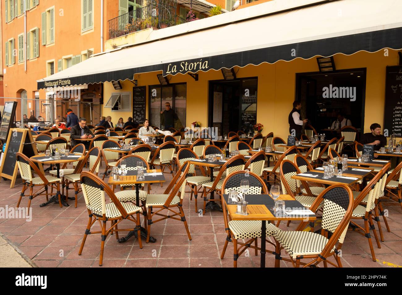 An outdoor cafe on the Cours Saleya in the Old Town of Nice, France ...