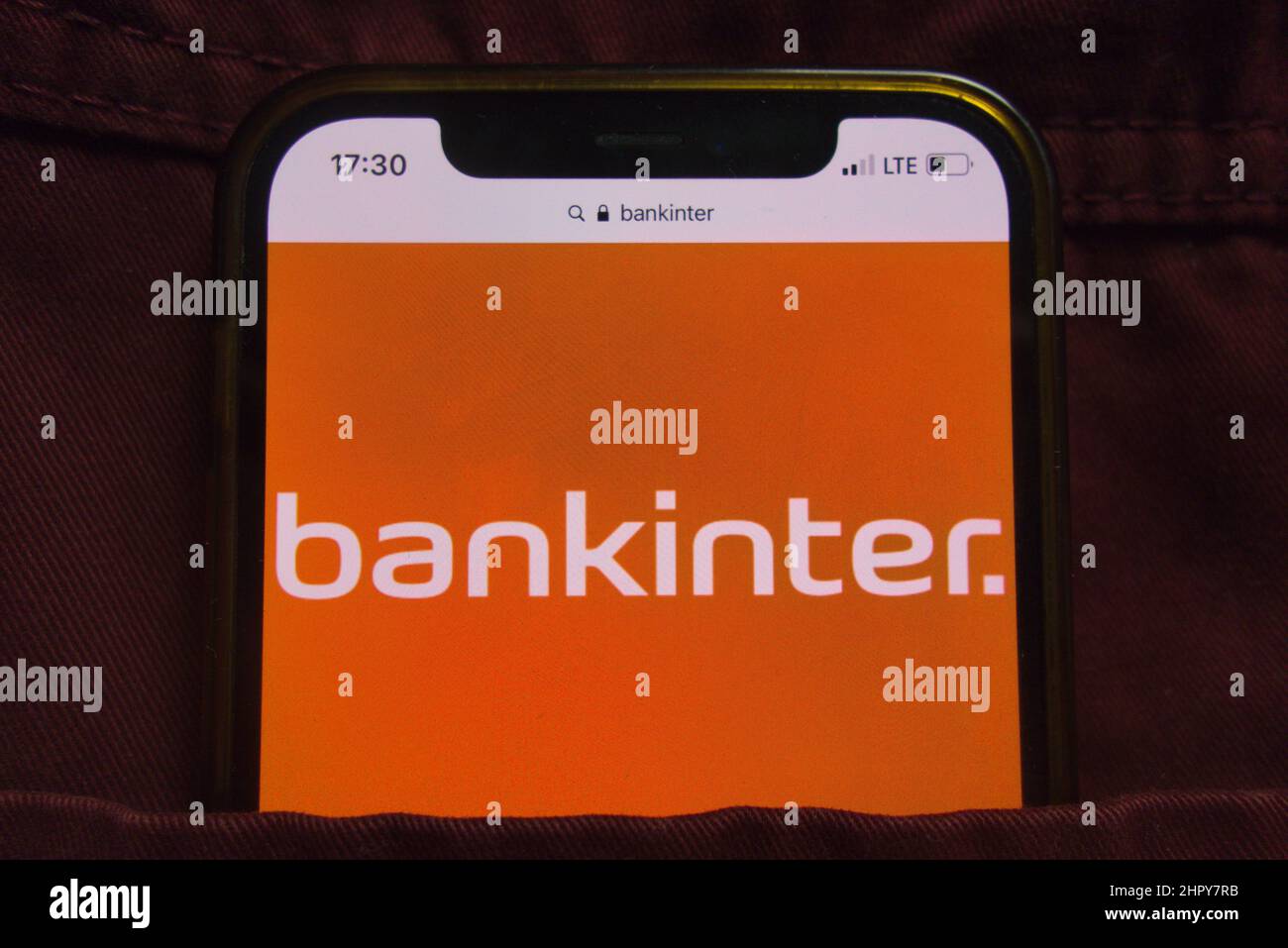 KONSKIE, POLAND - February 22, 2022: Bankinter SA logo displayed on mobile phone hidden in jeans ...