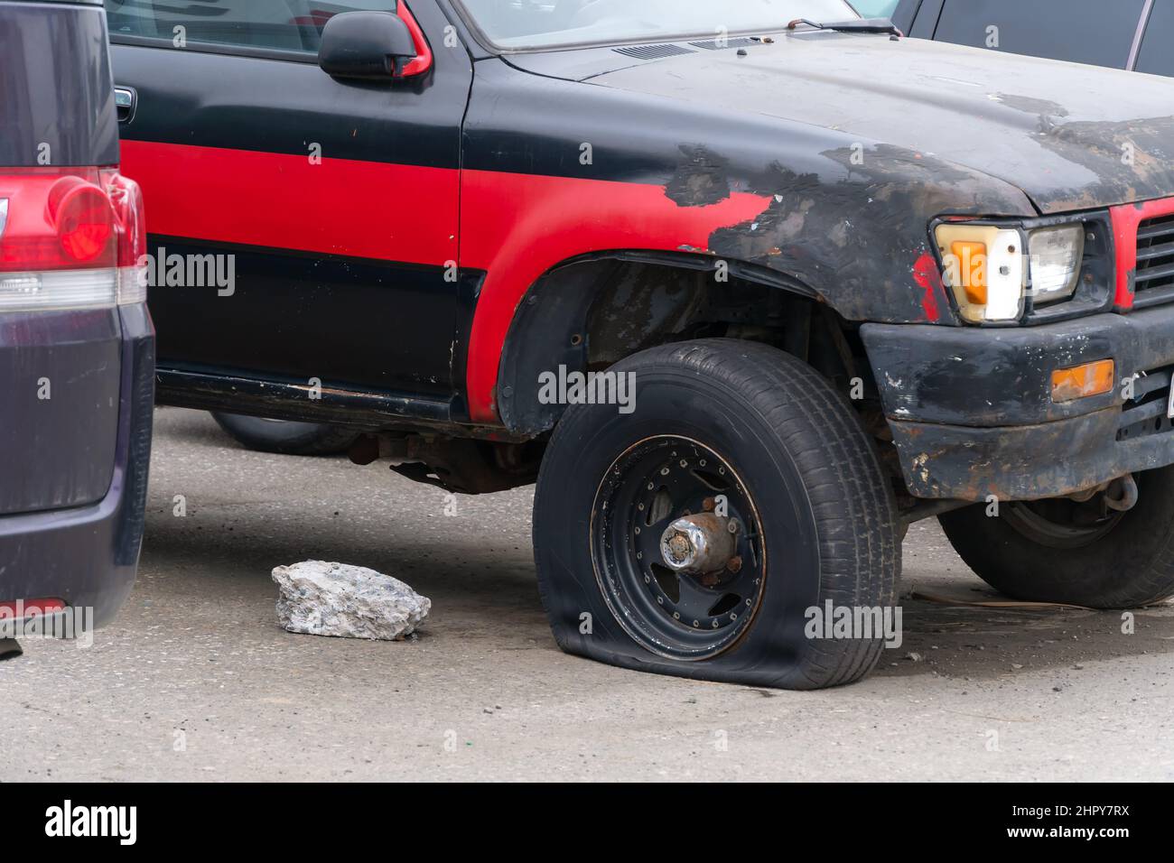 flat tire in an old rusty car. Car repair after an accident and being ...