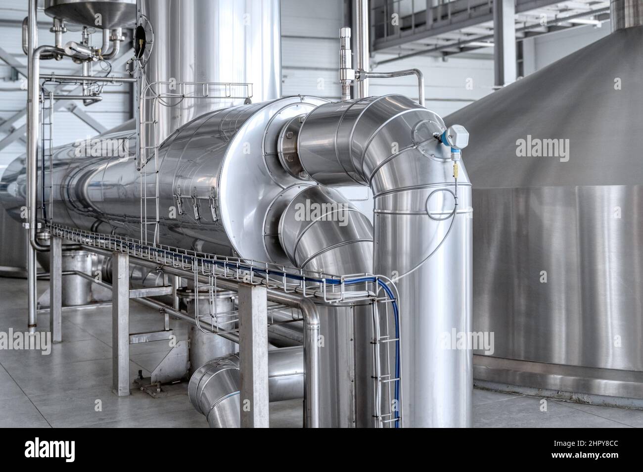 Thick insulated piping, stainless steel water pipes. Food factory Stock ...