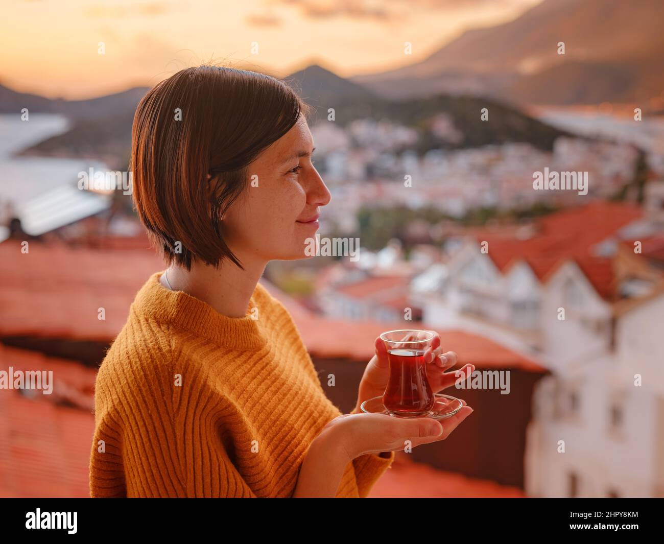 Woman drinking turkish tea from traditional turkish teacup and enjoys ...