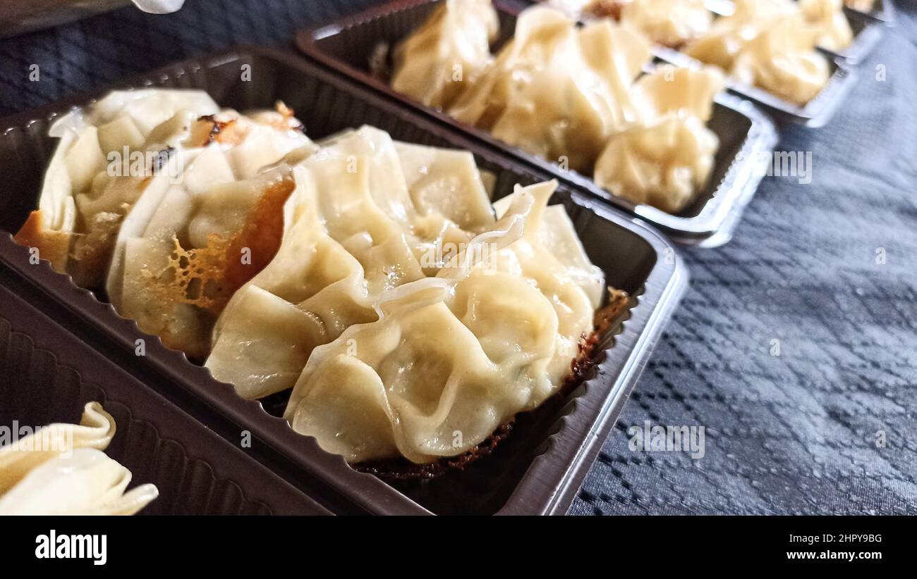 Many Japanese street food snack yoza on dark plastic tray for little ...