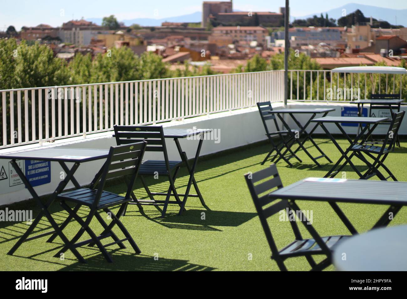 Terrace with chairs and tables with a view of the city in the ...