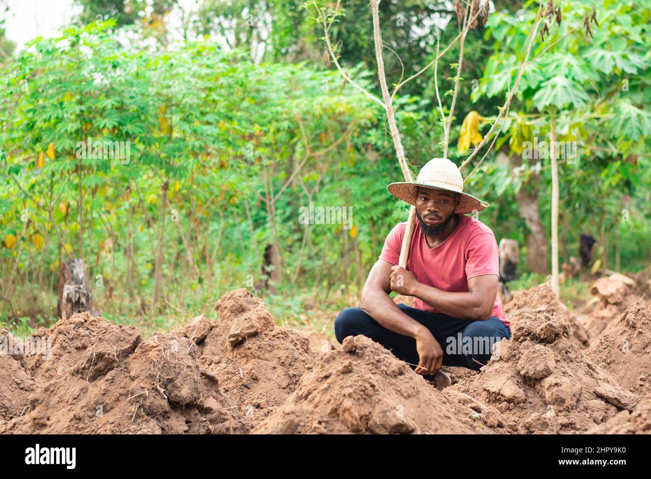 Tired African male farmer sitting in the farm Stock Photo - Alamy