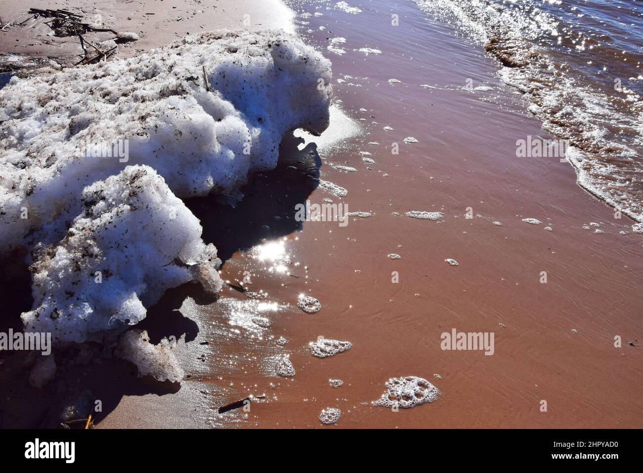 Brown wet sand and white melting snow near the beach Stock Photo - Alamy