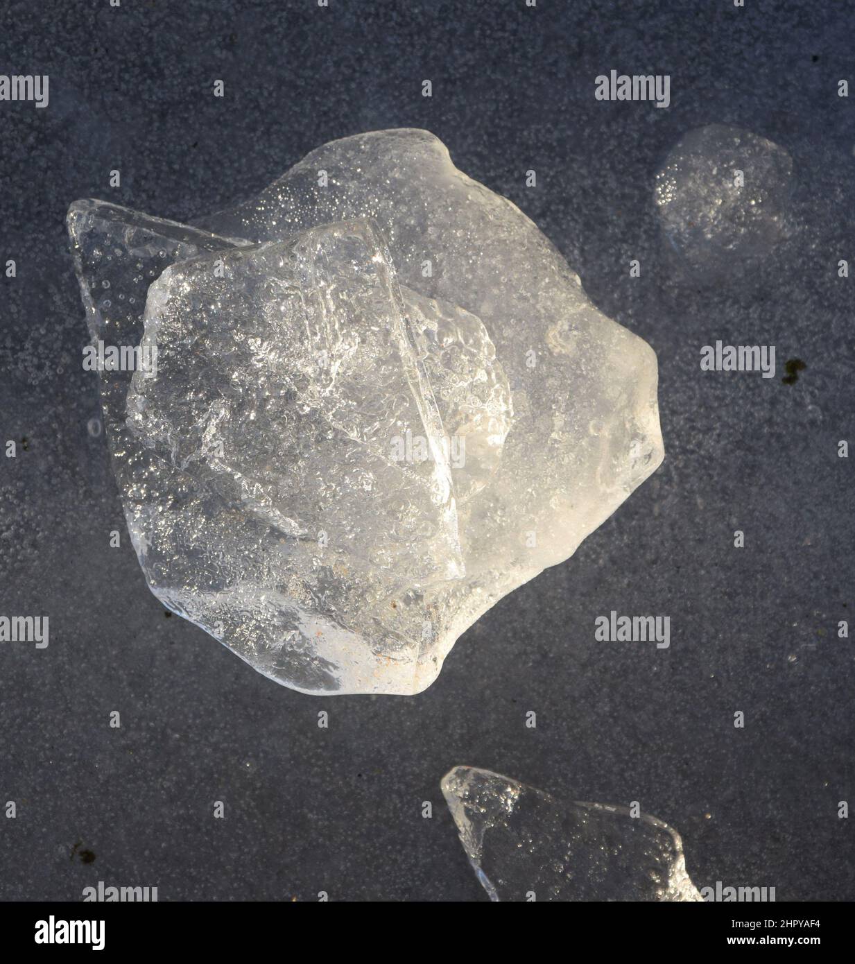 Closeup of a piece of ice with a dark grey background Stock Photo - Alamy