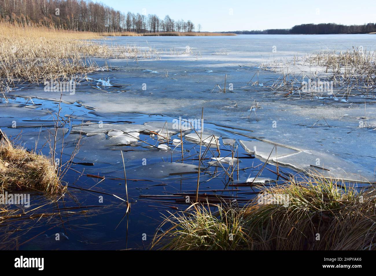 View of frozen ice pieces that are broken on the surface of a lake ...