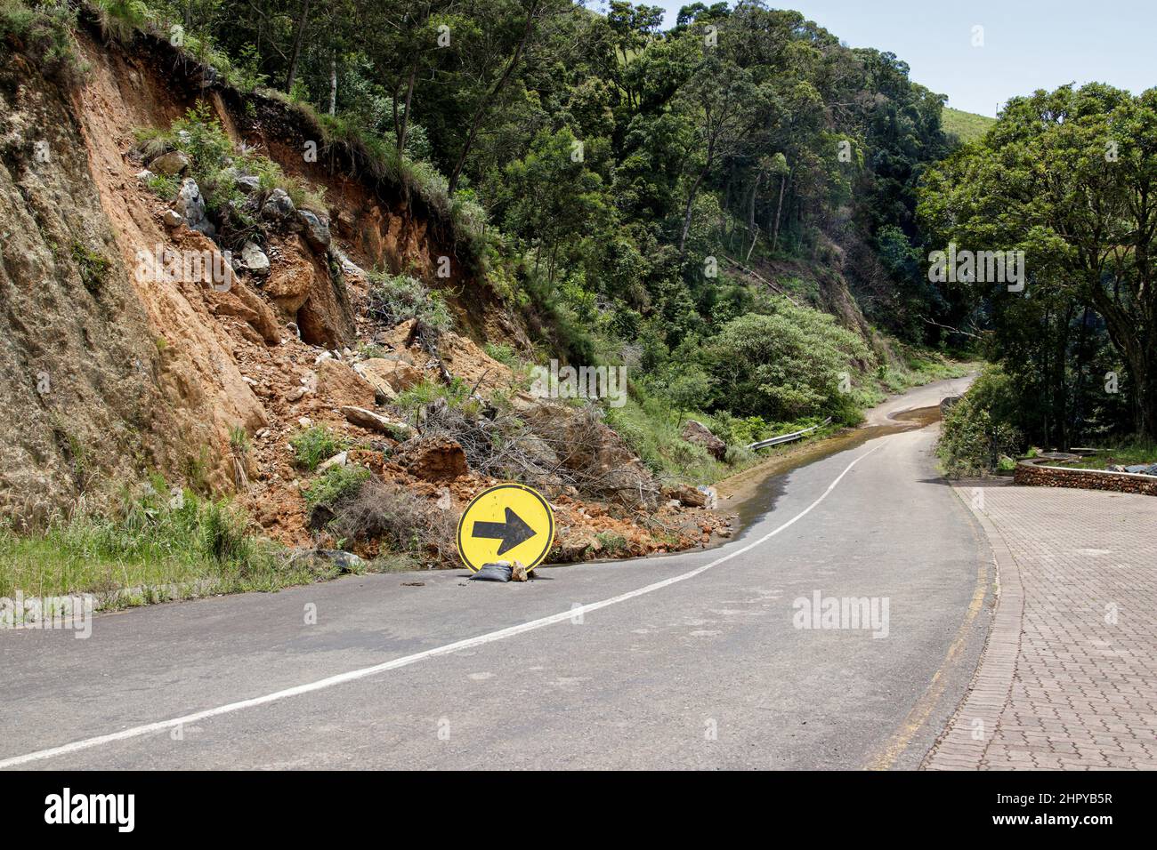 Highway with trees on the side and fallen traffic sign Stock Photo - Alamy