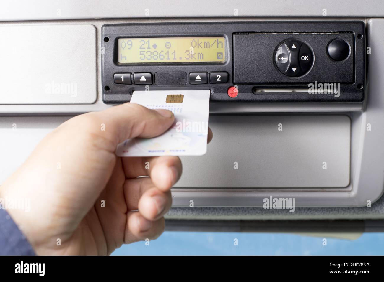 Digital tachograph and drivers hand inserting drivers card in it. No ...