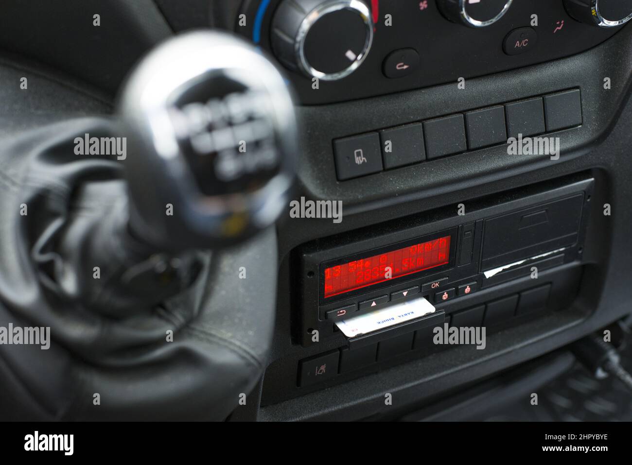 Blurred shot of a gear shifter in the background of a digital ...
