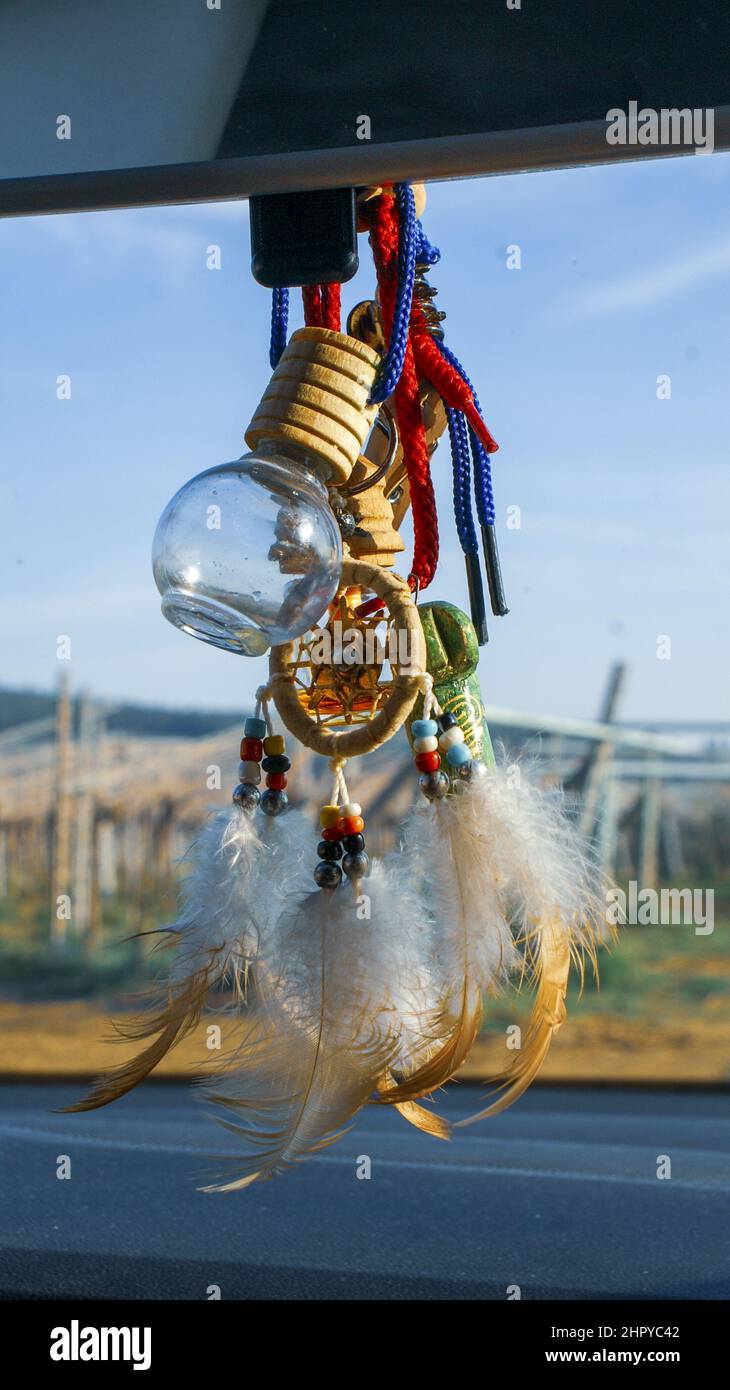 Closeup of decorations with feathers hanging in a car Stock Photo - Alamy