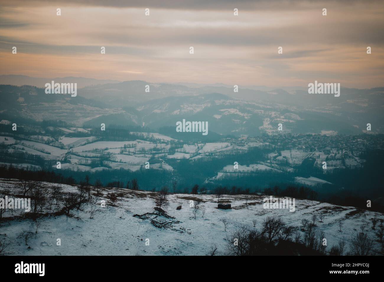 Foggy shot of a landscape under the cloudy skies on a cold day Stock ...