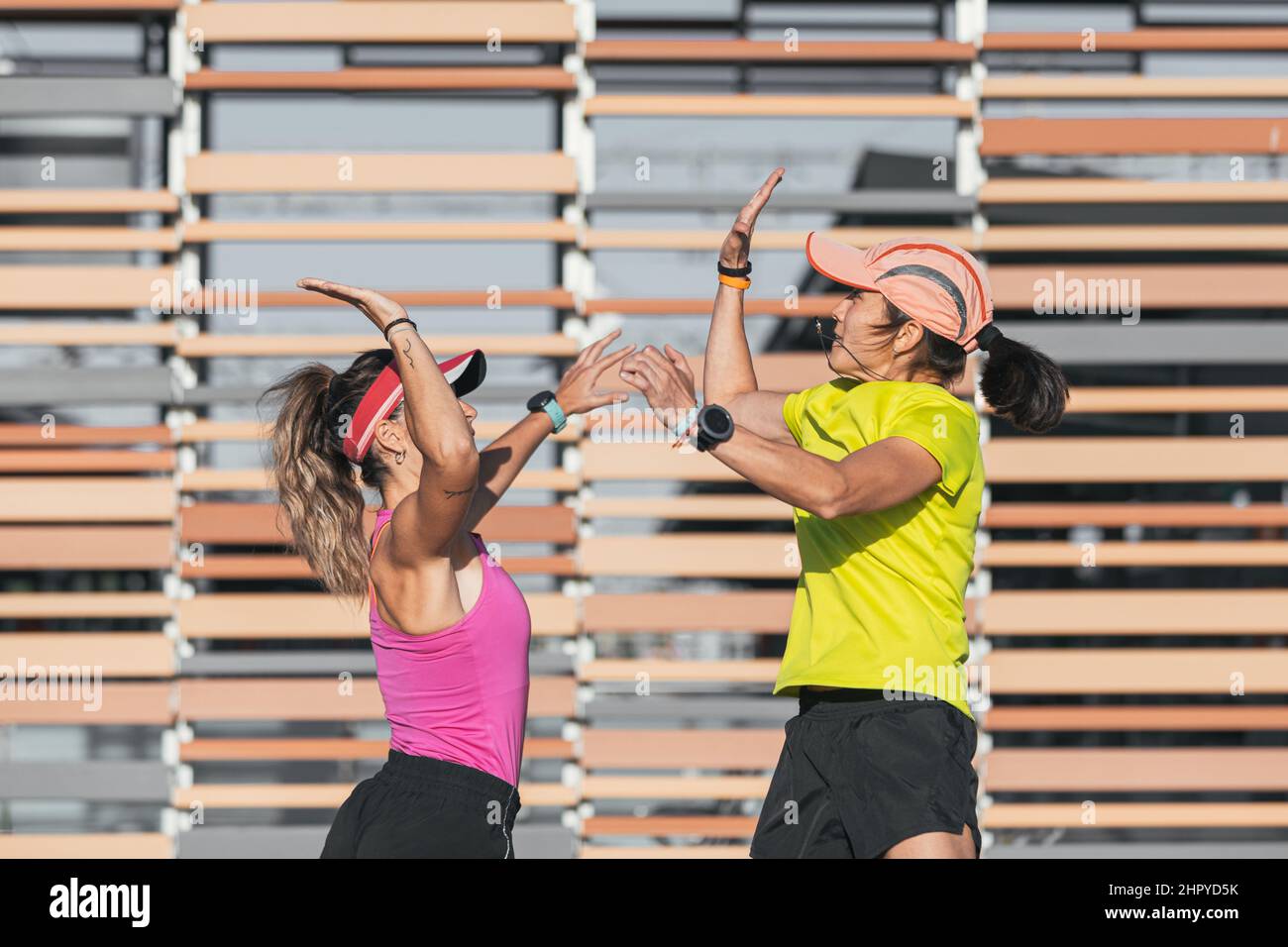 Two girls high-five, jumping up and down celebrating victory Stock ...