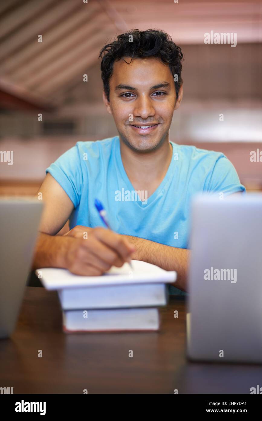 Finals No problem. Portrait of a handsome young student studying for ...