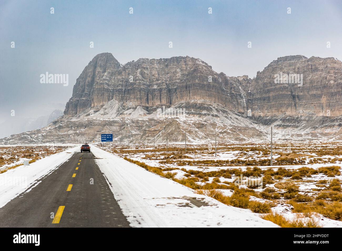 Car driving on a rural two lane snowy road, Bachu County, Xinjiang ...