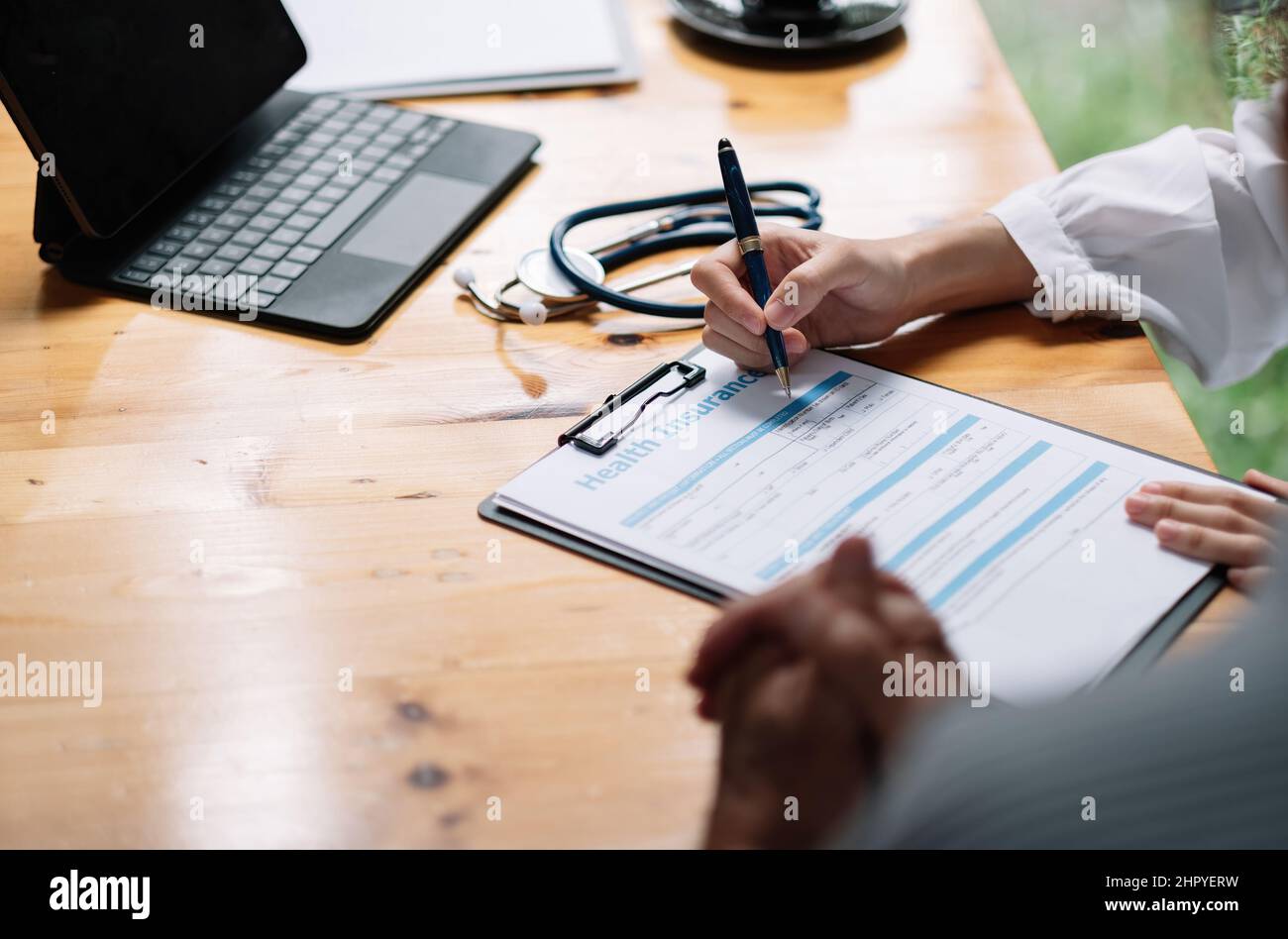Female health insurance broker presenting his insurance benefits to ...