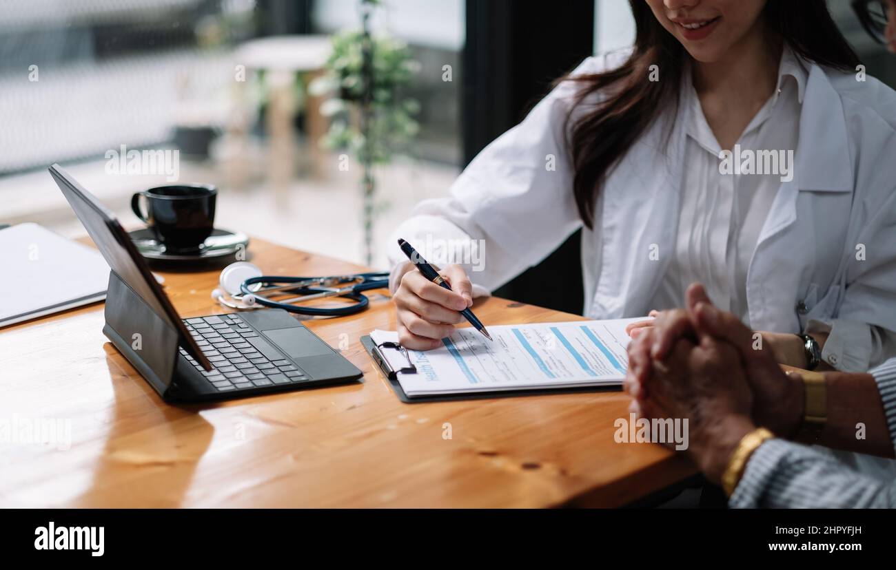 Female health insurance broker presenting his insurance benefits to ...