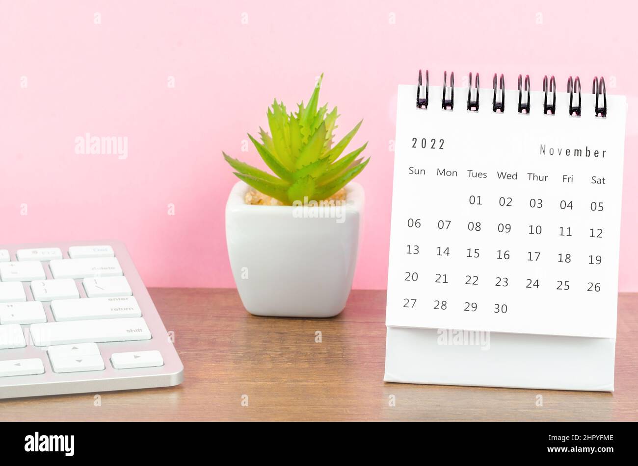 The November 2022 desk calendar with plant on wooden table Stock Photo ...
