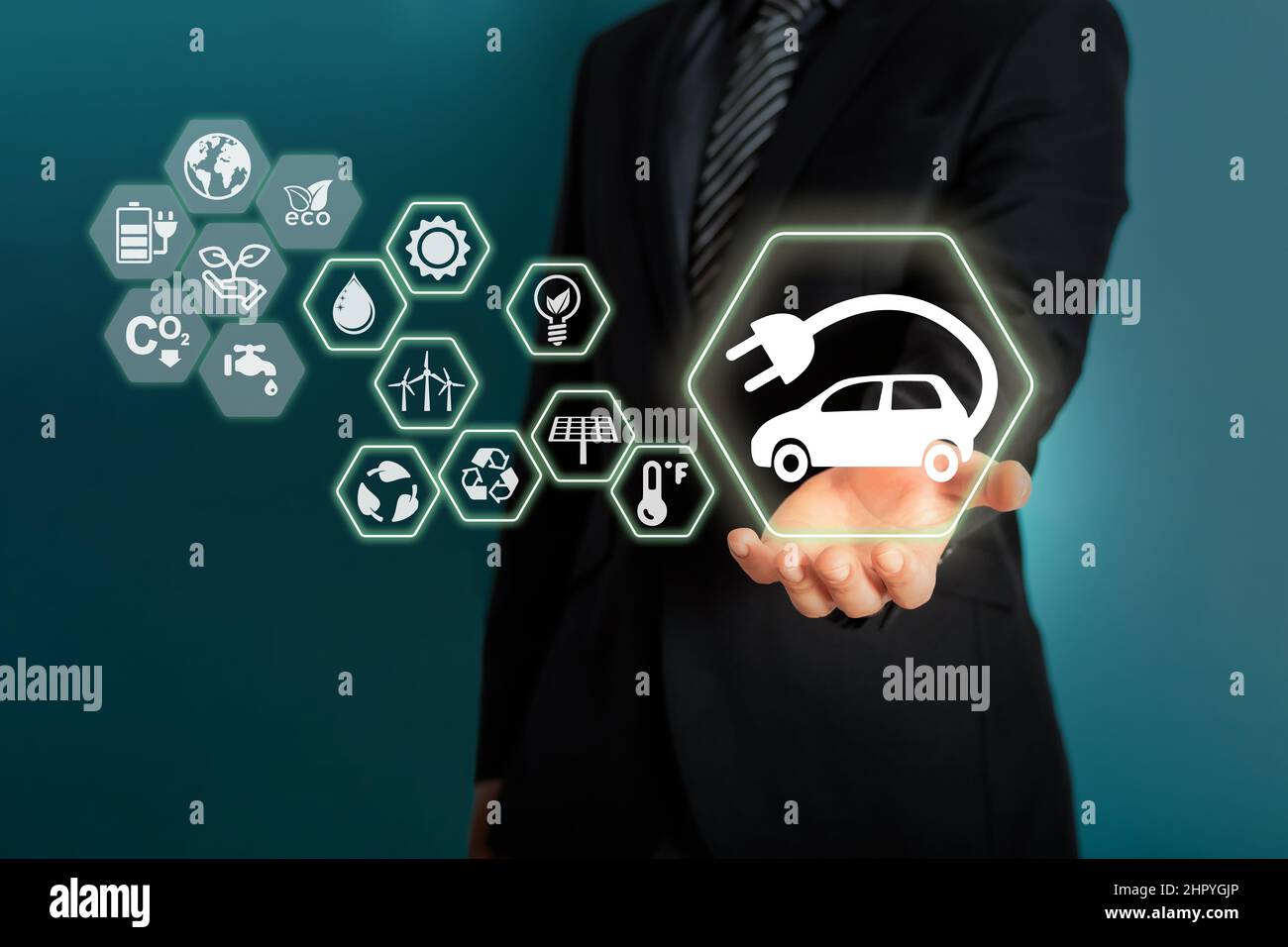 Closeup of a person showing a digital icon of an electric car with its ...