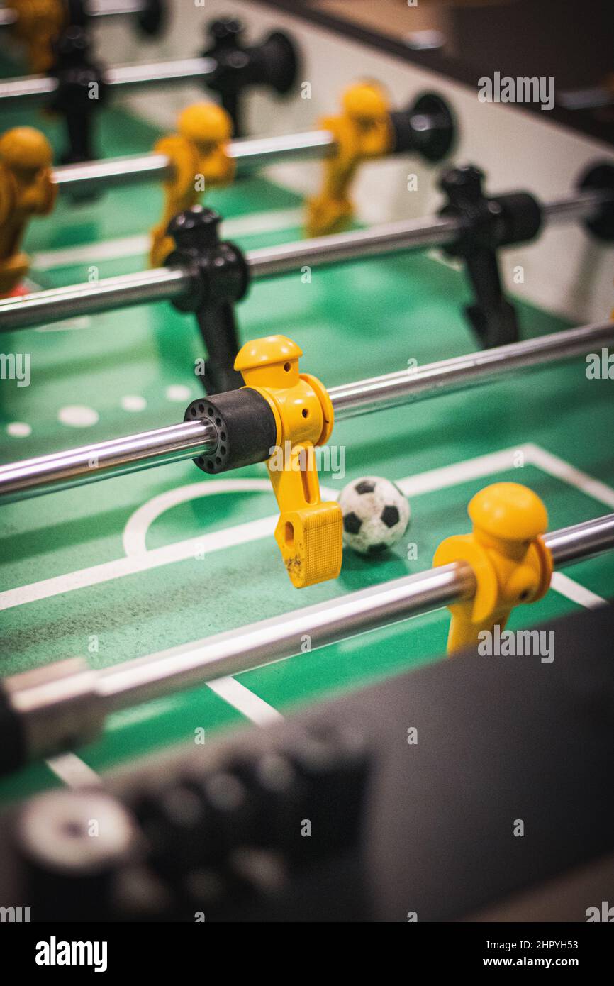 Vertical shot of table football with yellow and black players Stock ...