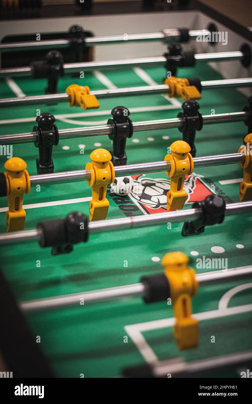 Vertical shot of table football with yellow and black players Stock ...