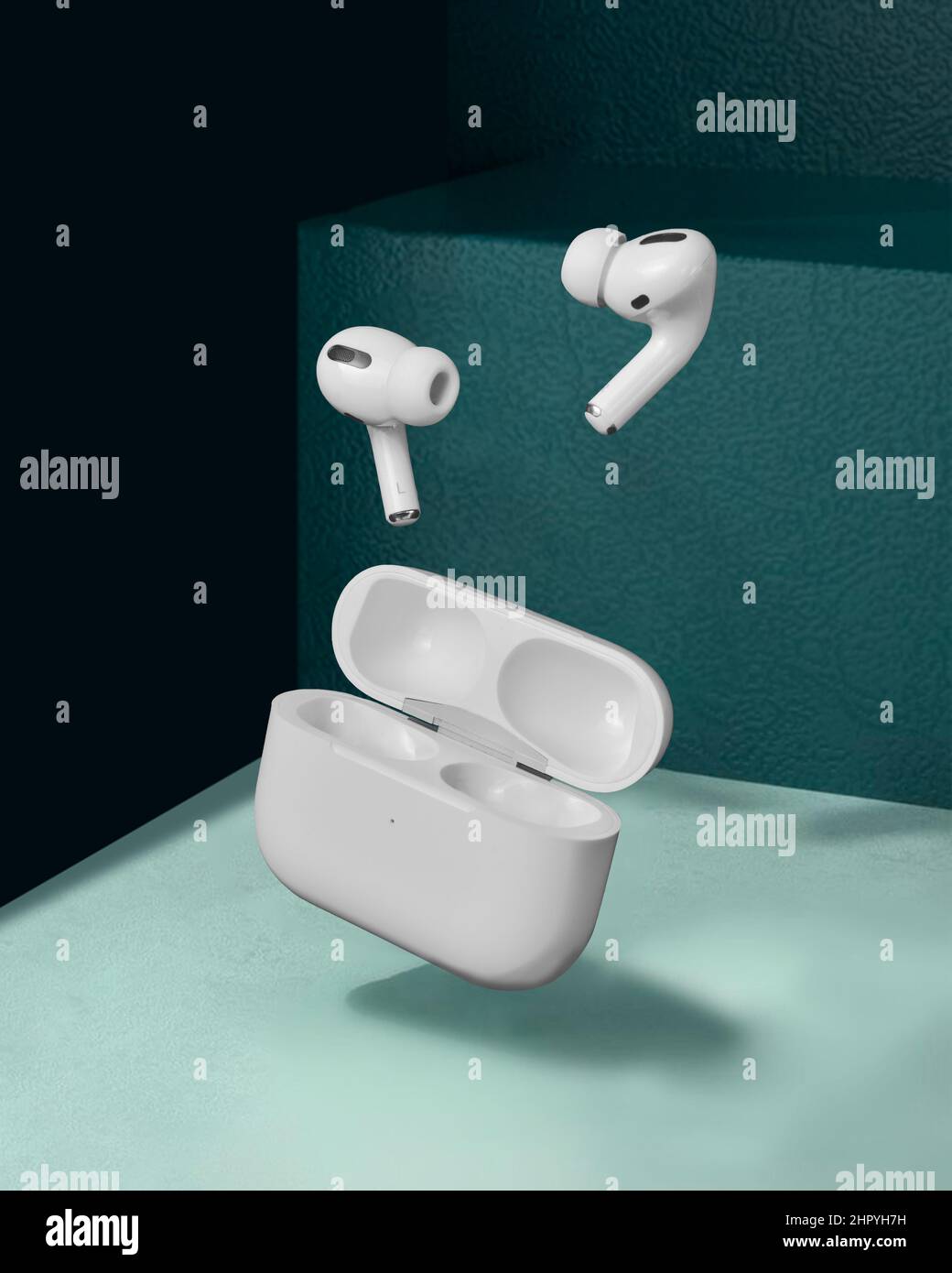 View of white Air Pods with dual microphone flying with blue background ...