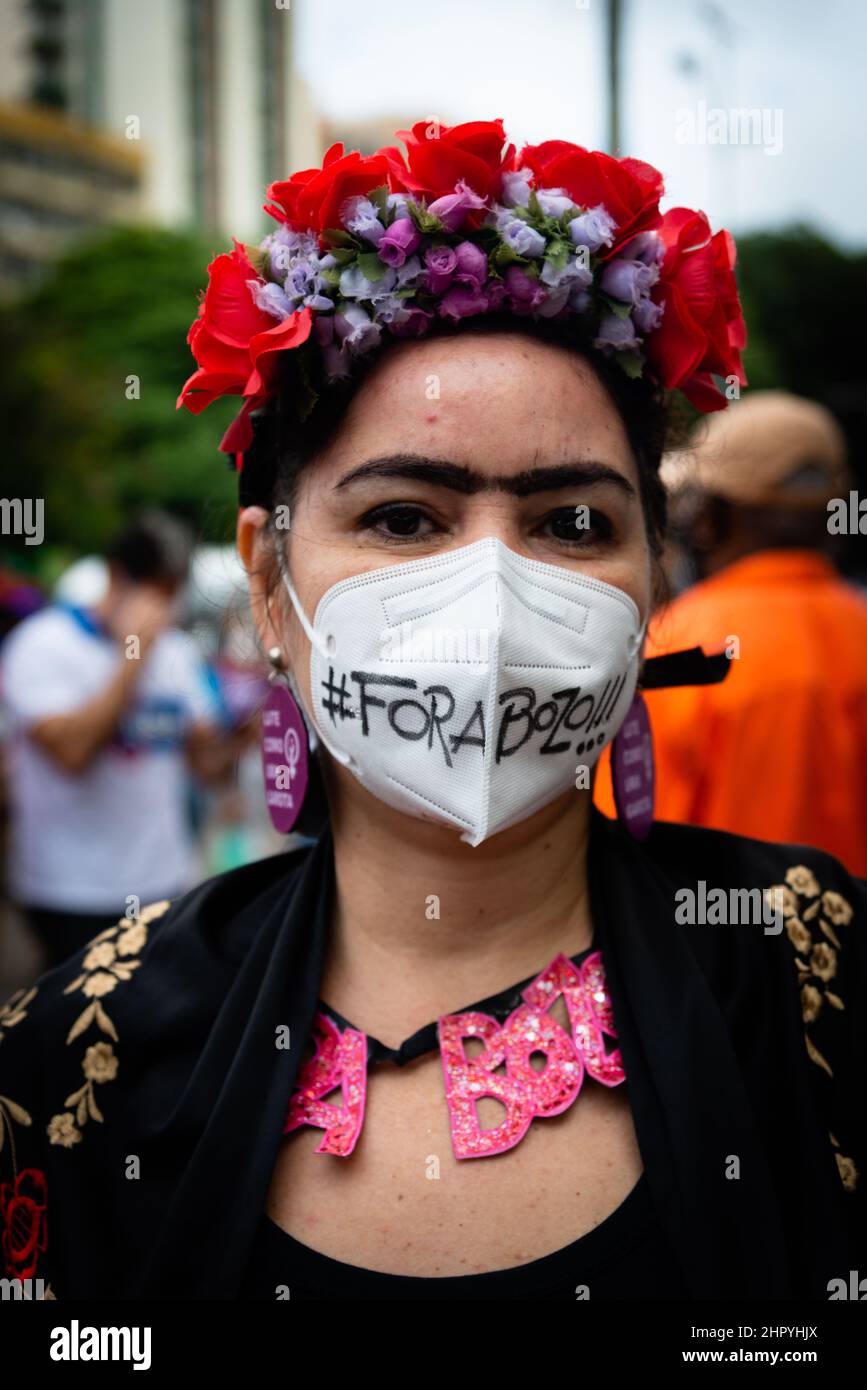 Young Brazilian female in a mask and a Frida Kahlo outfit protesting ...