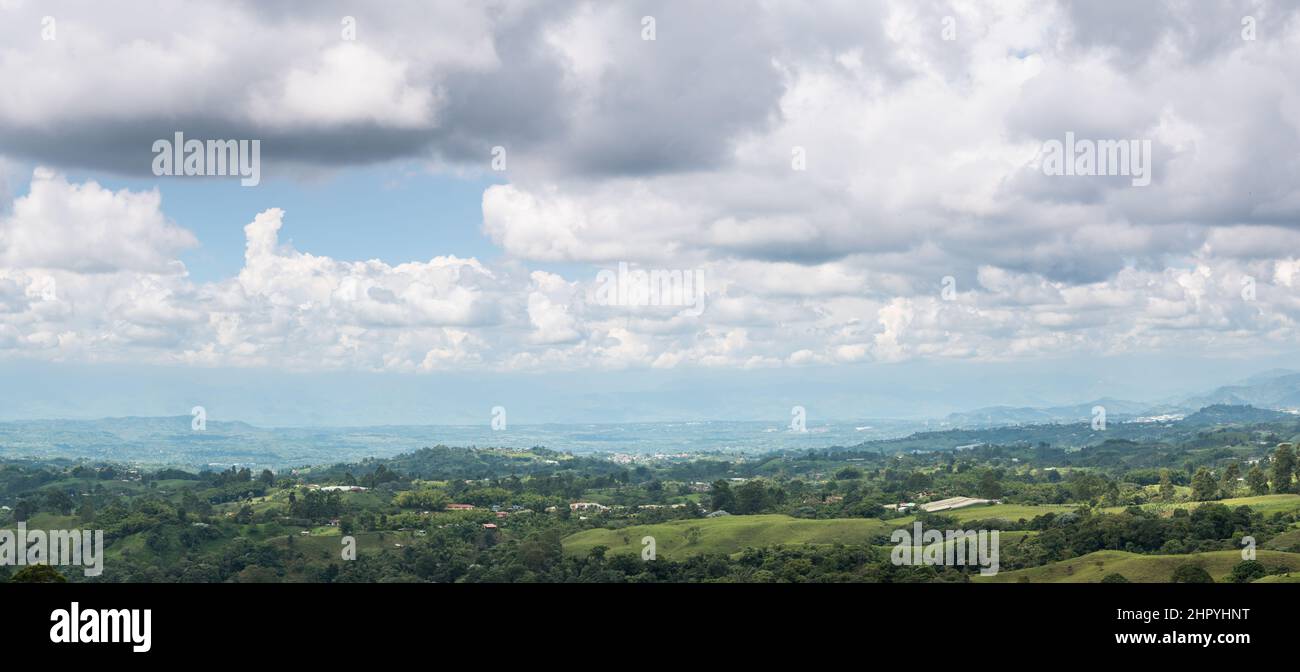 Rural area with growing trees under a cloudy sky Stock Photo - Alamy