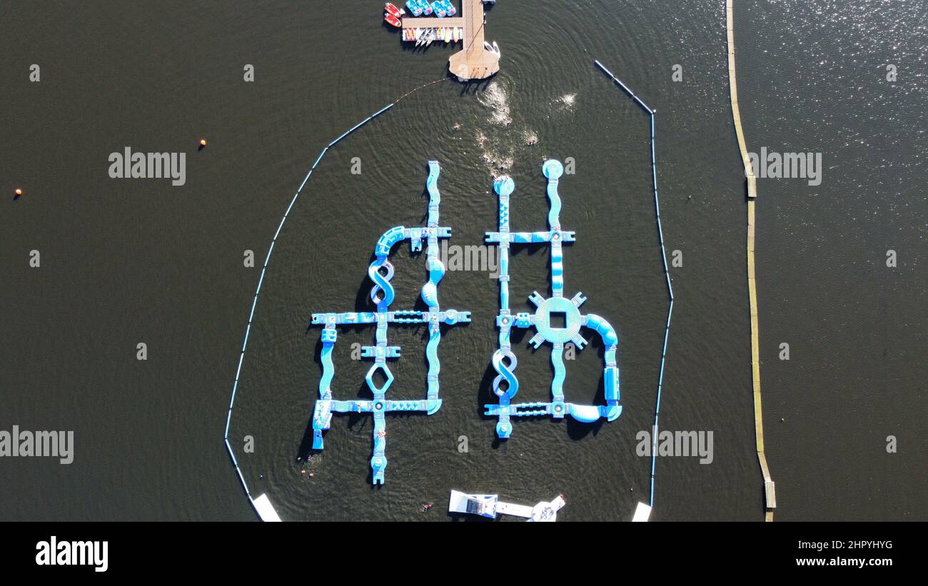 Aerial shot of the aqua park with floating obstacles on the sea water ...