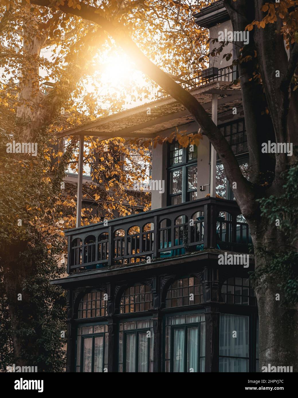 Beautiful view of Sunset raising on a rural black house with wooden ...