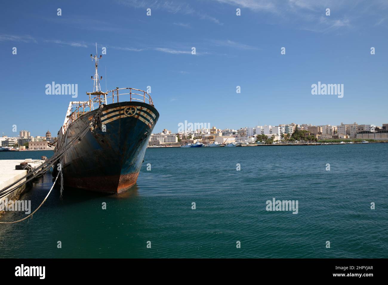 Marsala Marina with abandoned boat moored on the jetty. Italy Stock ...